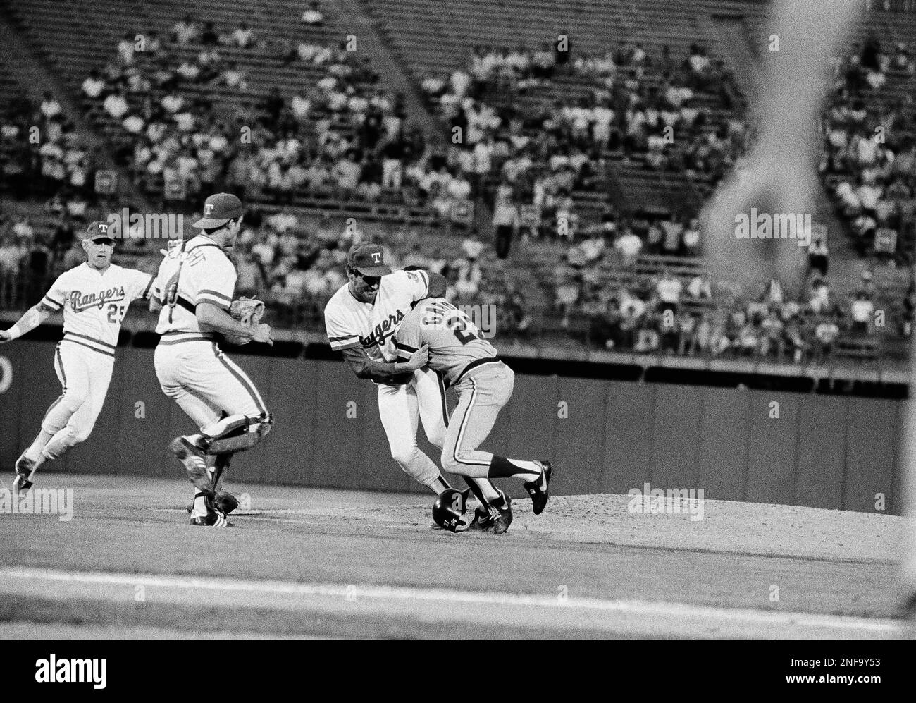 Detroit Tigers' first baseman Barbaro Garbey (27) wrestles with Texas ...