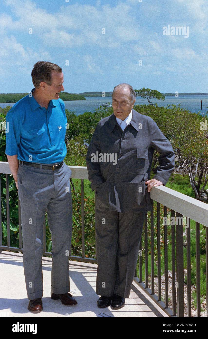 President George Bush and French President Francois Mitterrand relax at ...