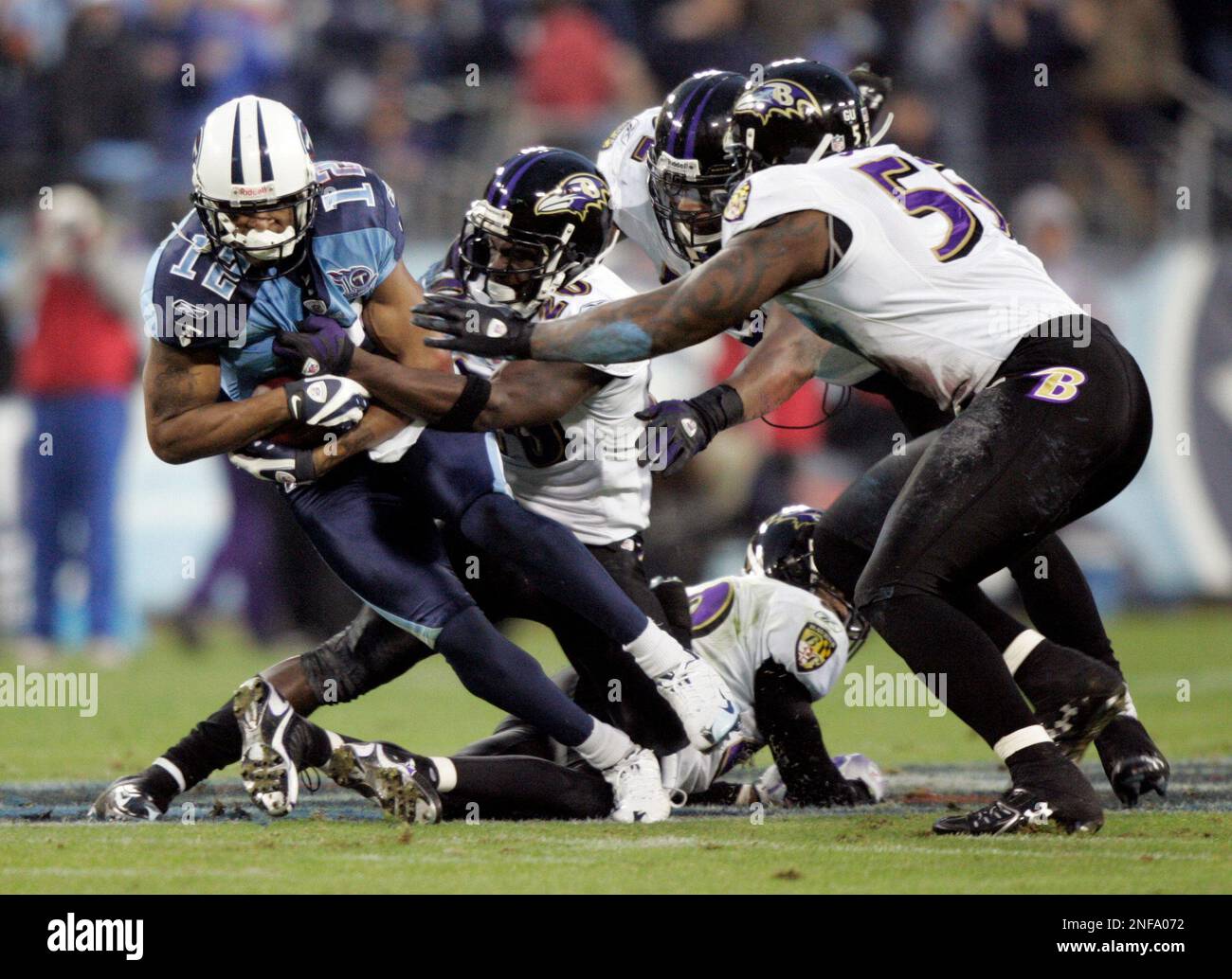 Tennessee Titans wide receiver Justin Gage (12) is brought down by a ...