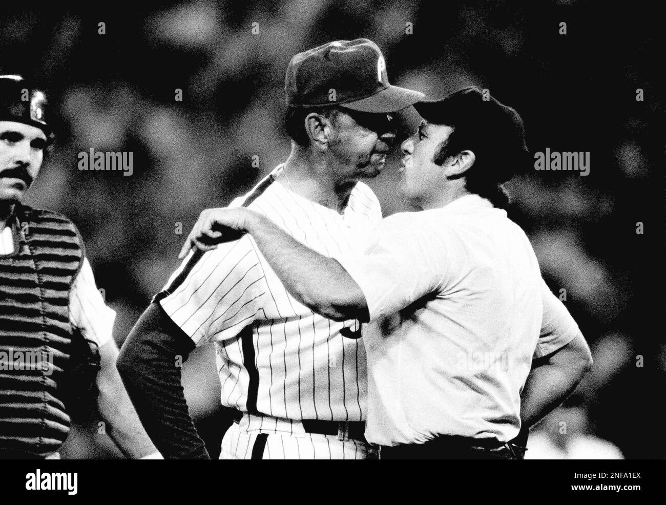 Phillies manager Danny Ozark, center, goes eye to eye with plate umpire ...