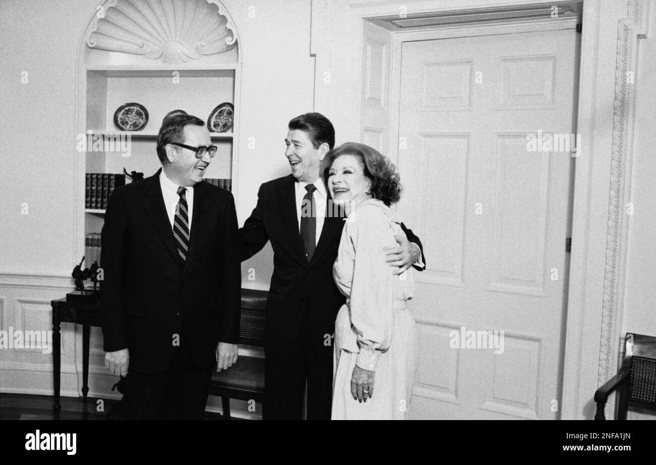 U.S. President Ronald Reagan is flanked by actress Amanda Blake and ...