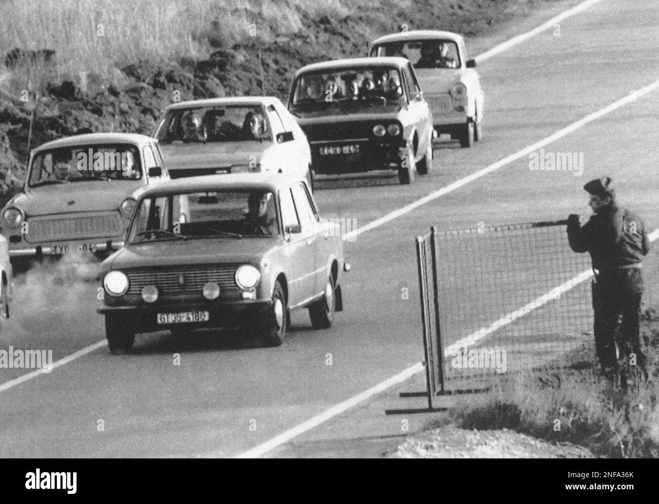 An East German border guard pulls the last fence away from the old ...