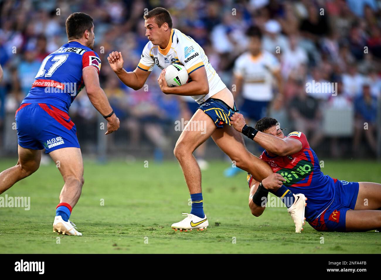 Jake Arthur of the Eels is tackled by Leo Thompson of the Knights ...