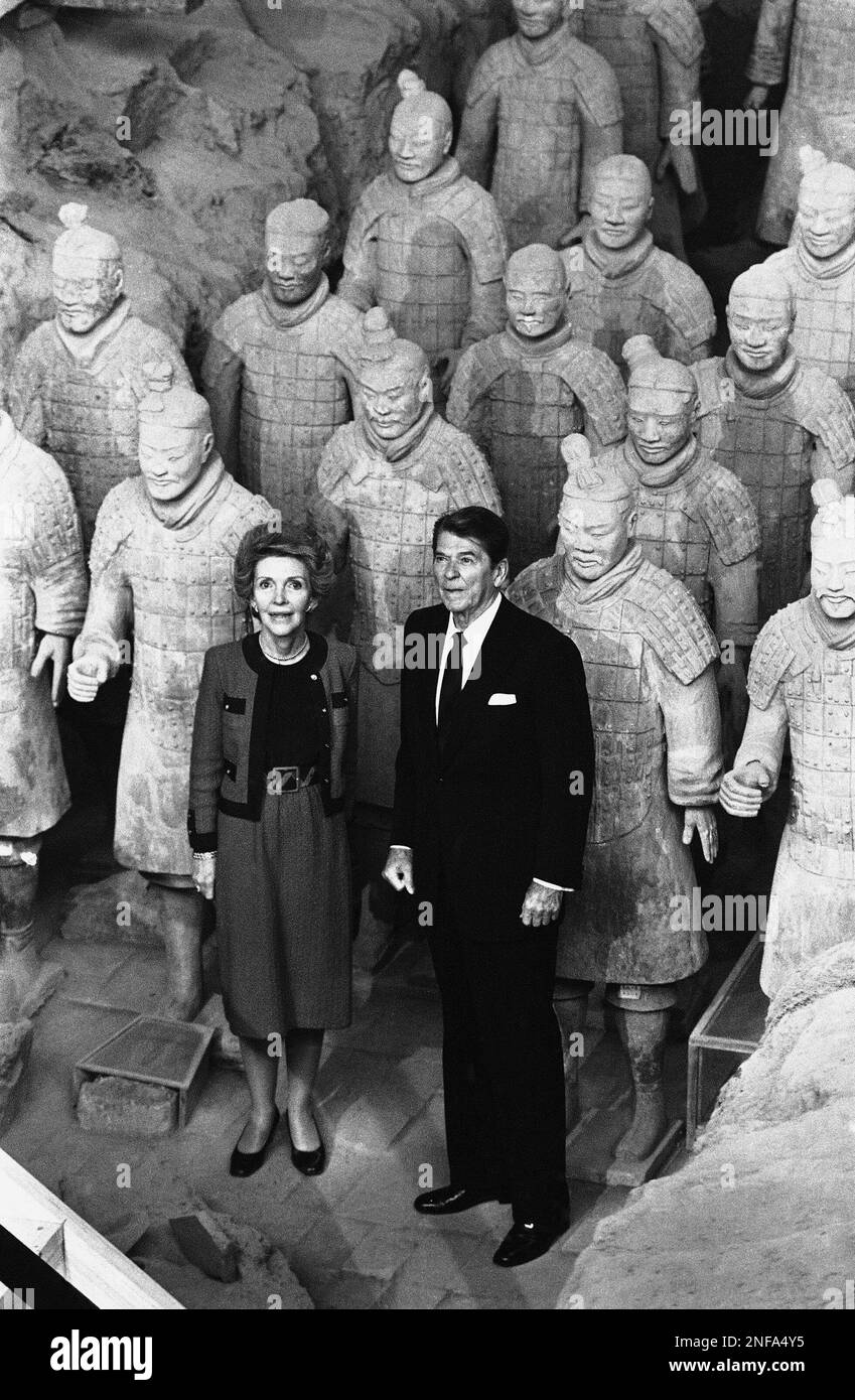 President Ronald Reagan and first lady Nancy Reagan pose with a group ...