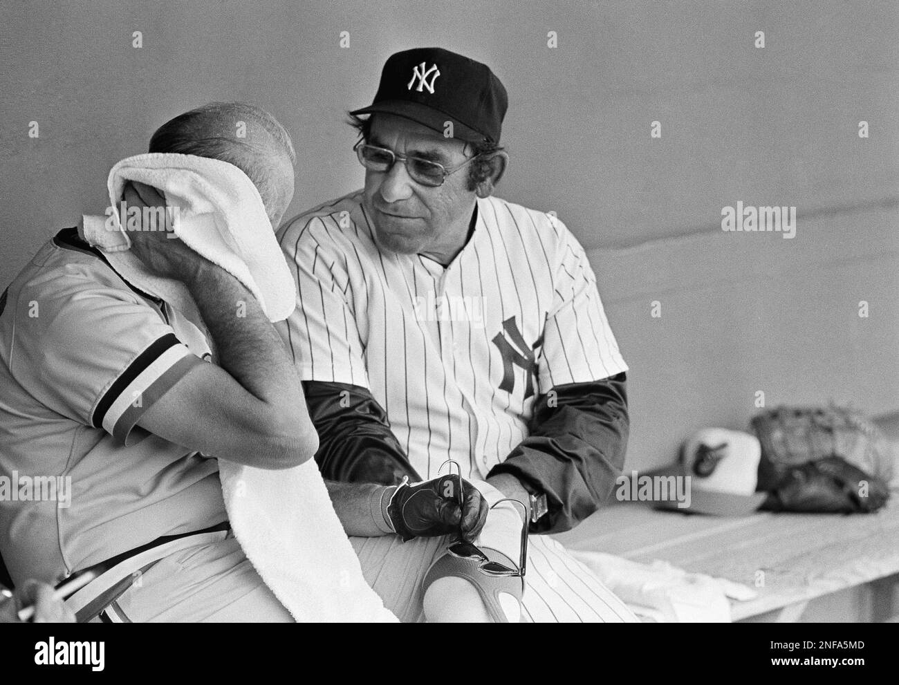 New York Yankee coach Yogi Berra joins Baltimore Orioles coach Billy Hunter on March 1977 in the ...