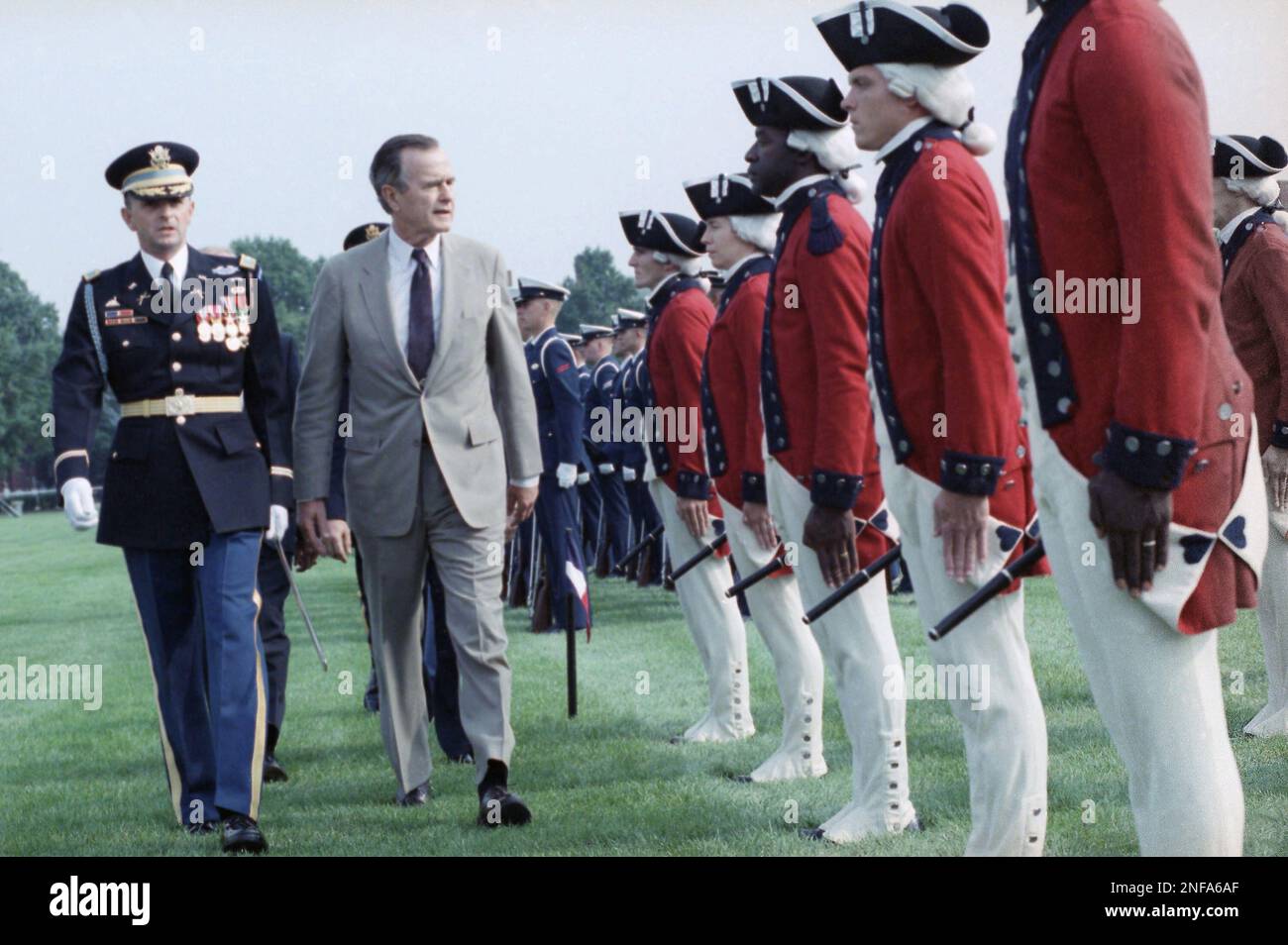 President George Bush, escorted by Colonel Barrie E. Zais, commander of ...