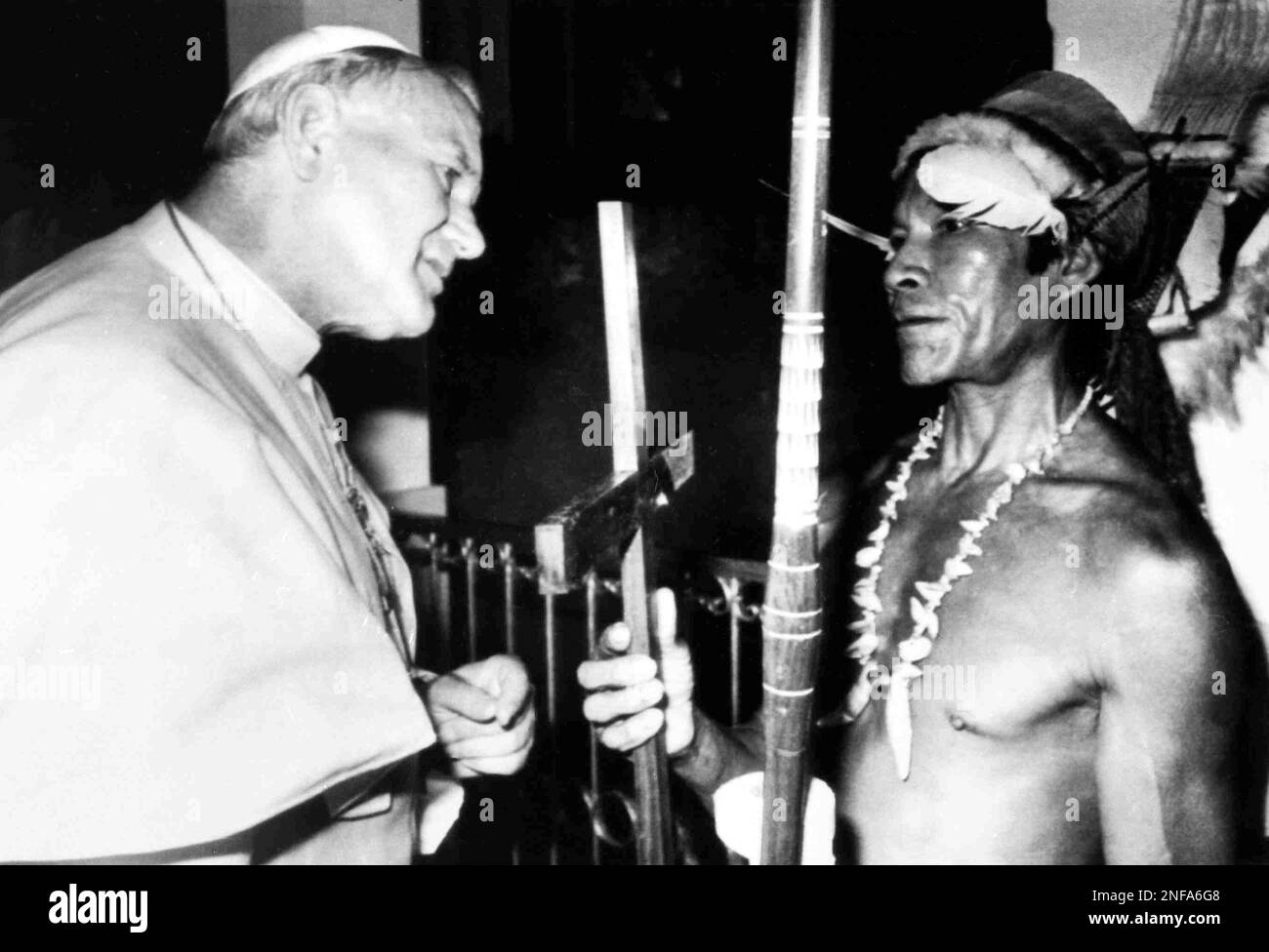 Pope John Paul II talks with an indian, wearing his native dress ...