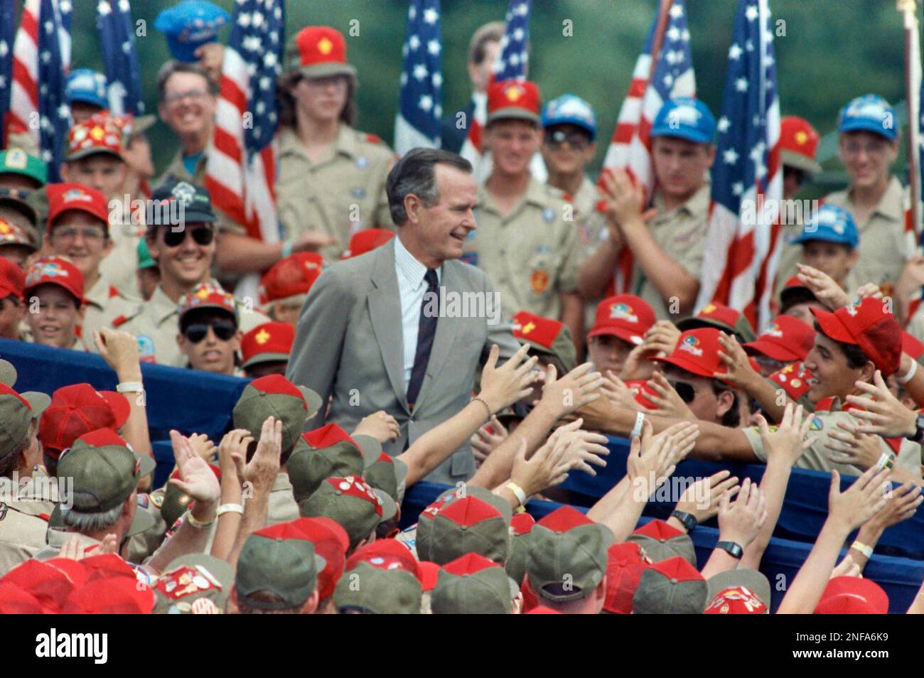 President George Bush walks through a group of Boy Scouts as he arrives ...