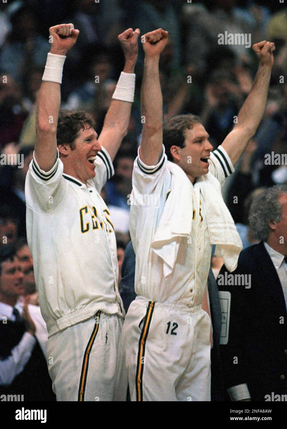Boston Celtics Bill Walton, left, and Jerry Sichting raise their hands ...