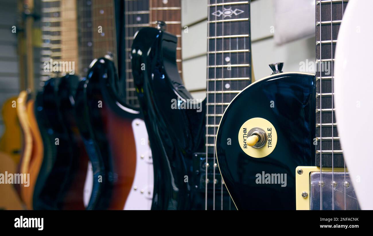 Electric guitars on a music store showcase close-up Stock Photo - Alamy