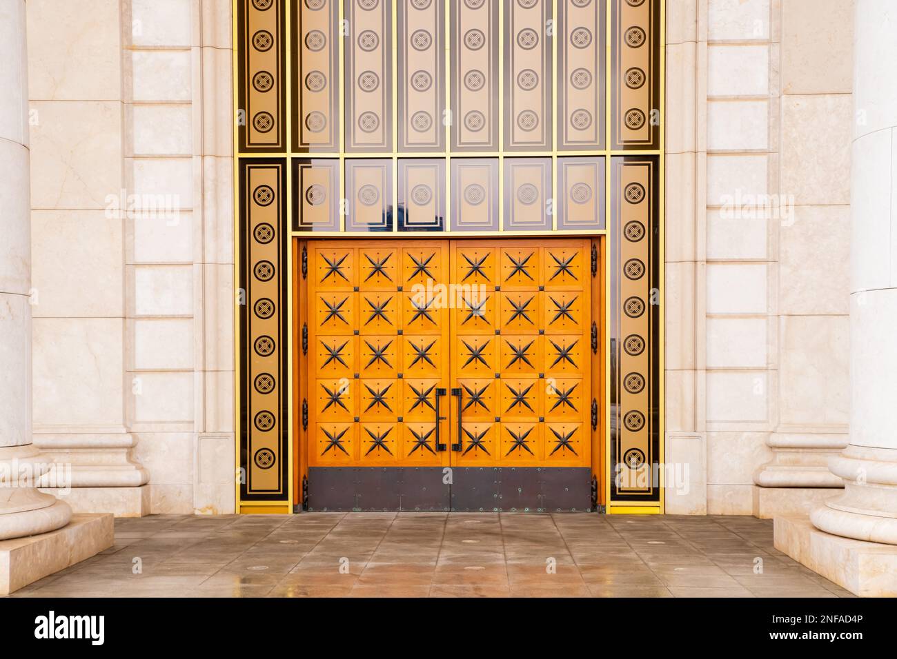 Yellow orange large wooden doors decorated with metal stars. Close-up ...