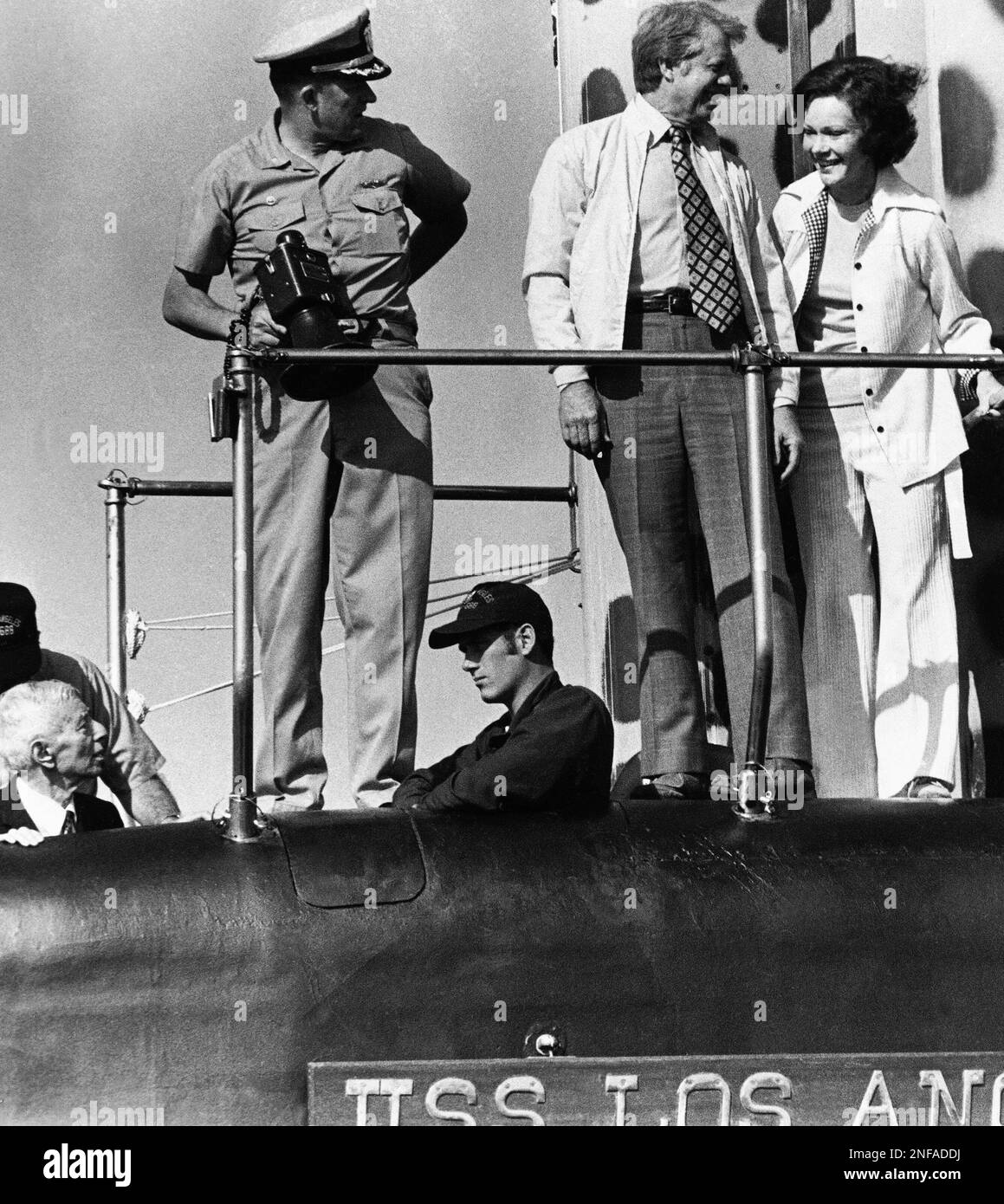 U.S. President Jimmy Carter and wife Rosalynn stand aboard the sail of ...