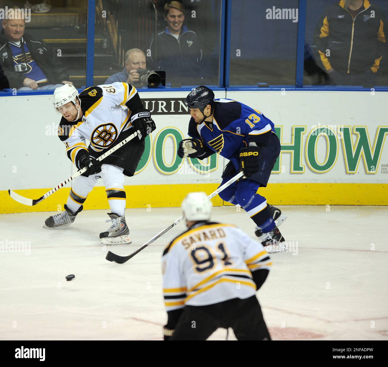 Boston Bruins' Phil Kessel (81) passes to teammate Marc Savard (91) as ...