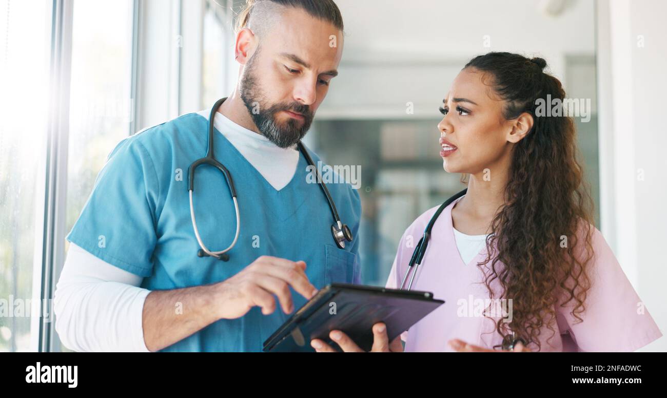 Healthcare, tablet and medical team surgeon and nurse talking ...