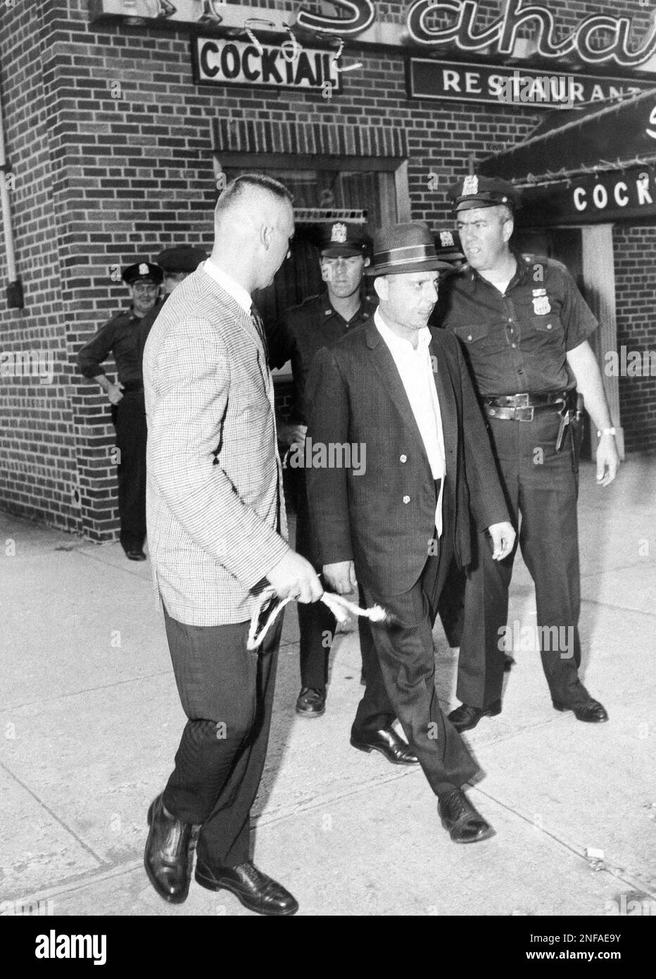 A detective holds a piece of the rope which four men were twisting ...