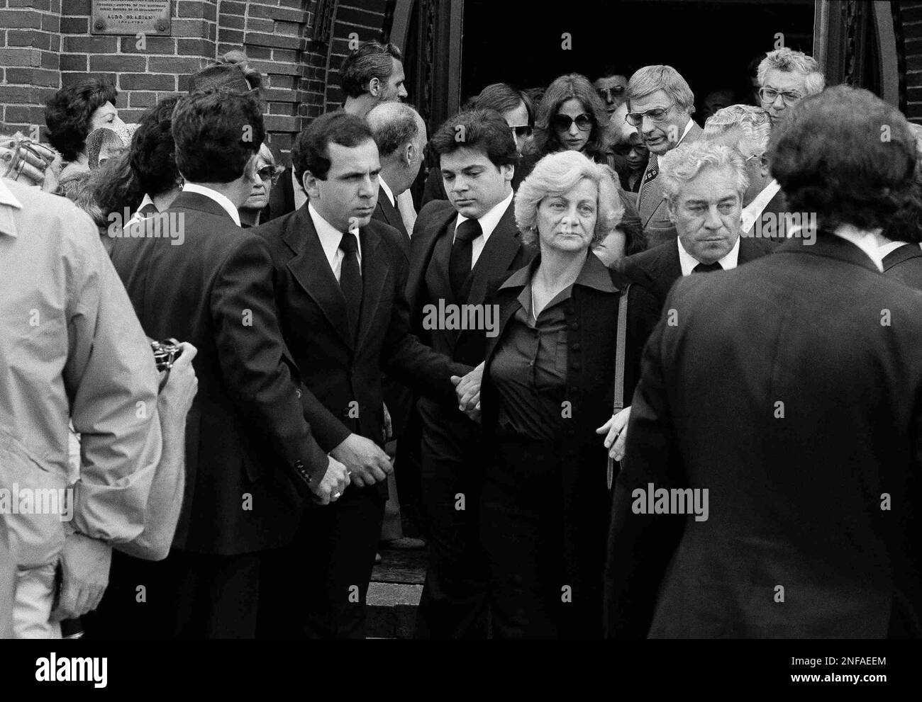 Lucille Colombo, center, leaves St. Bernadette's church in the ...