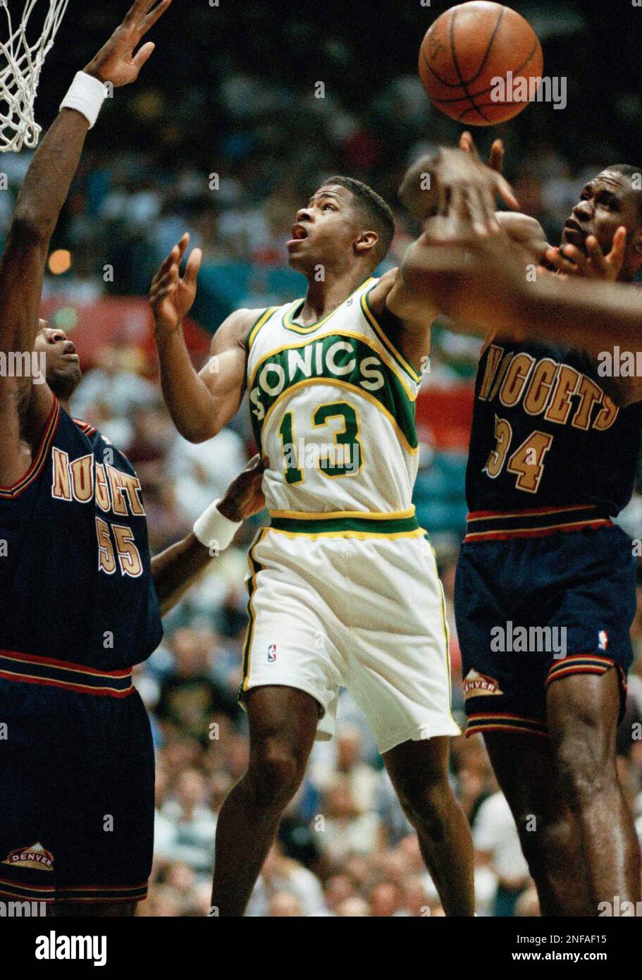 Seattle SuperSonics Kendall Gill, center, gets tangled with Denver ...
