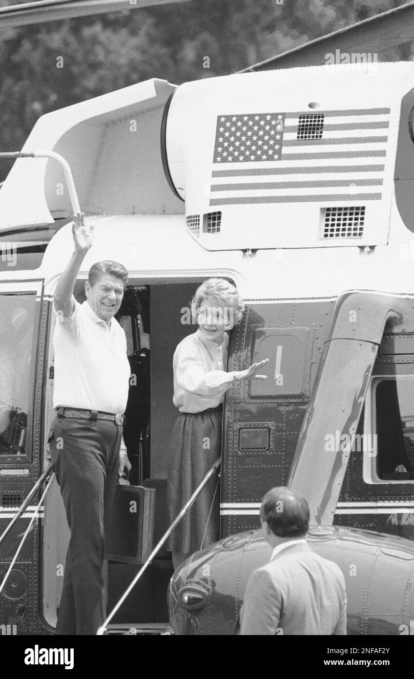 President Ronald Reagan and first lady Nancy Reagan wave as they board ...