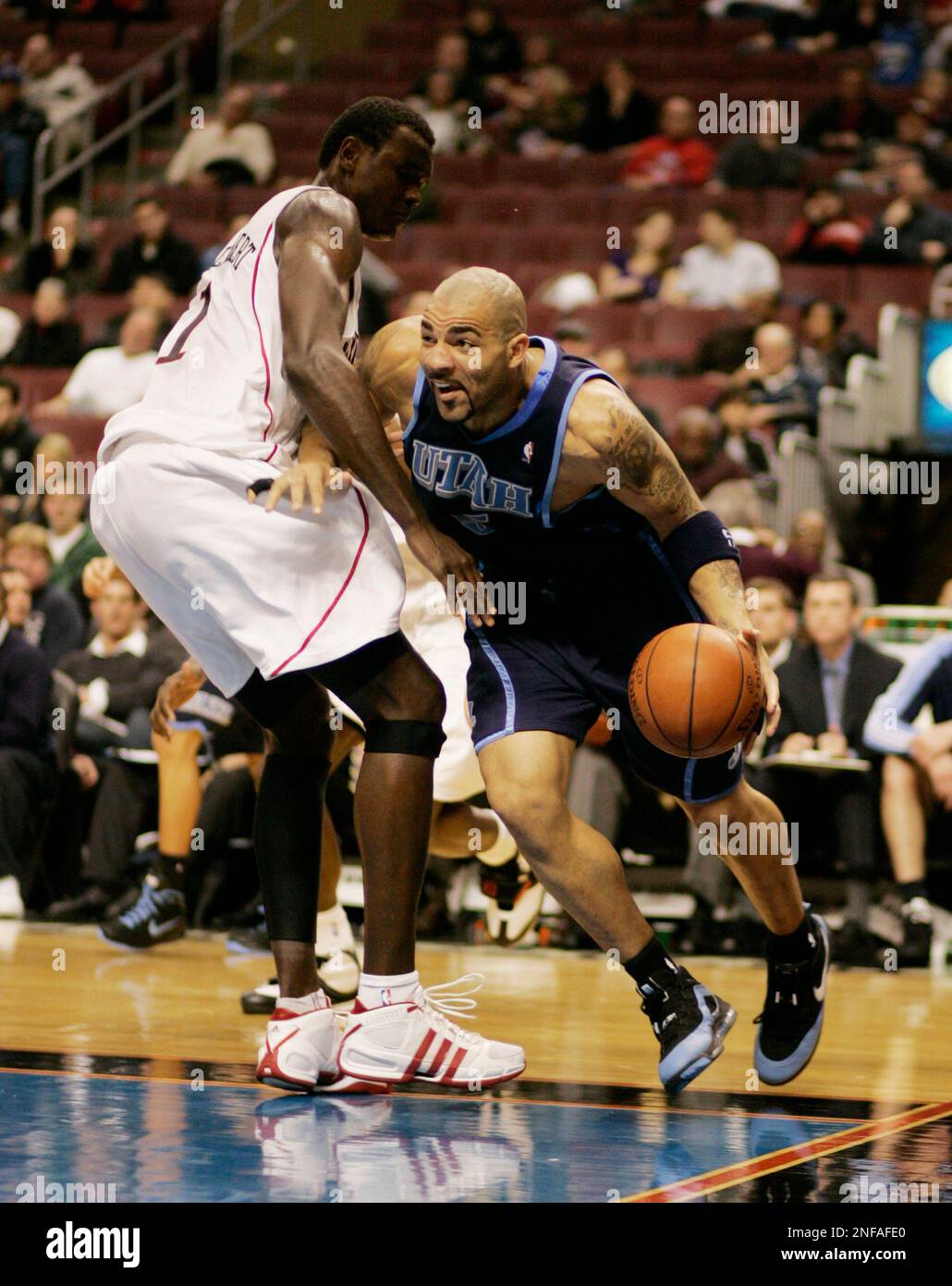 Utah Jazz Carlos Boozer drives past Philadelphia 76ers Samuel Dalembert ...