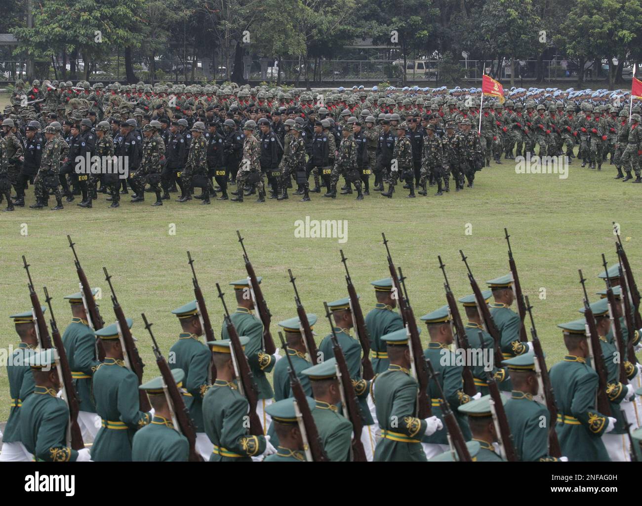 Philippine troops march past the grandstand at a parade-and-review ...