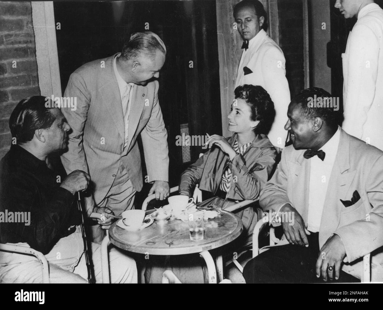 Pictured sitting at a table on the terrace of the Excelsior Hotel from ...