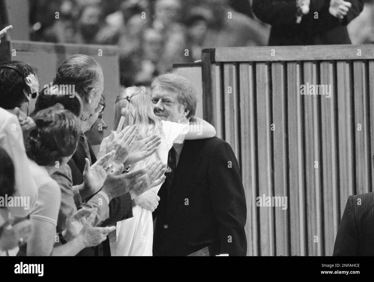 Jimmy Carter hugs his eight-year-old daughter, Amy, as he makes his way ...