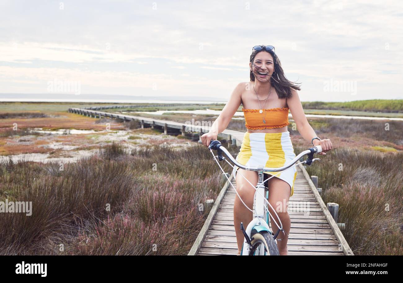 Portrait, bike and mockup with a woman cycling outdoor in nature for ...