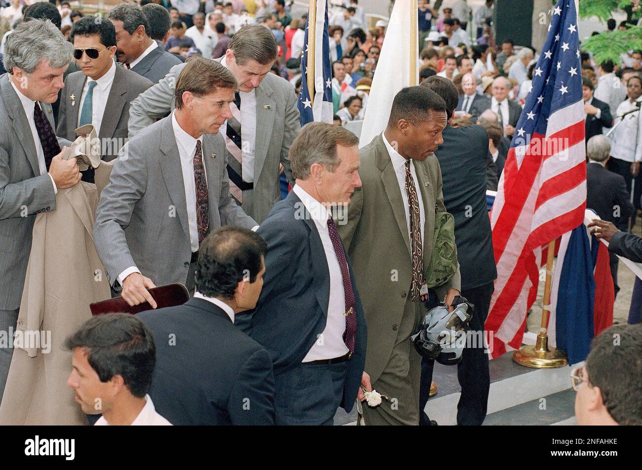 U.S. President George H. Bush is escorted from the podium by Secret ...