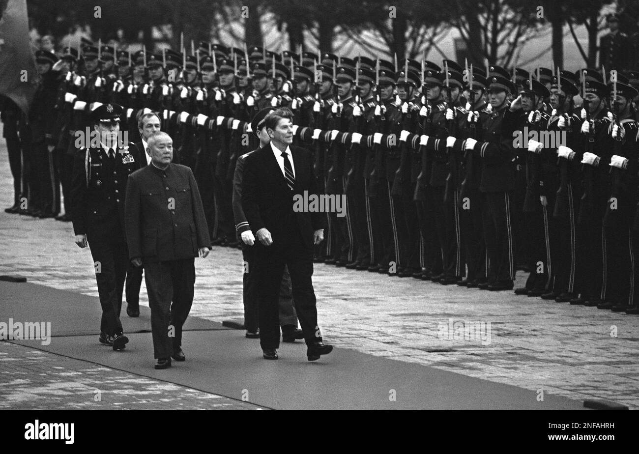 China's President Li Xiannian and President Ronald Reagan review the ...