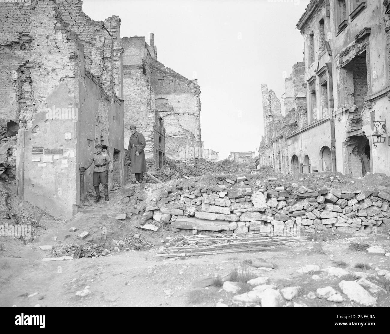 Two German soldiers make their way through the gutted city of Warsaw ...