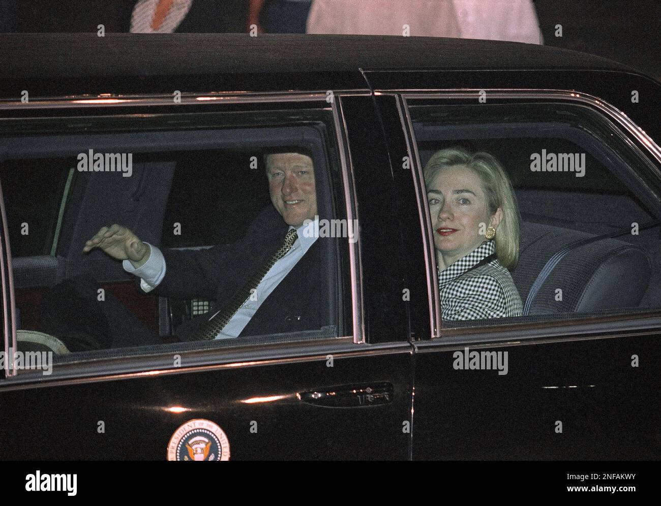 U.S. first lady Hillary Rodham Clinton waves from a limousine leaving ...