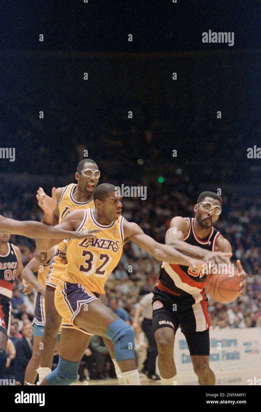 Los Angeles Lakers Earvin “Magic” Johnson (32) tries for a steal from ...