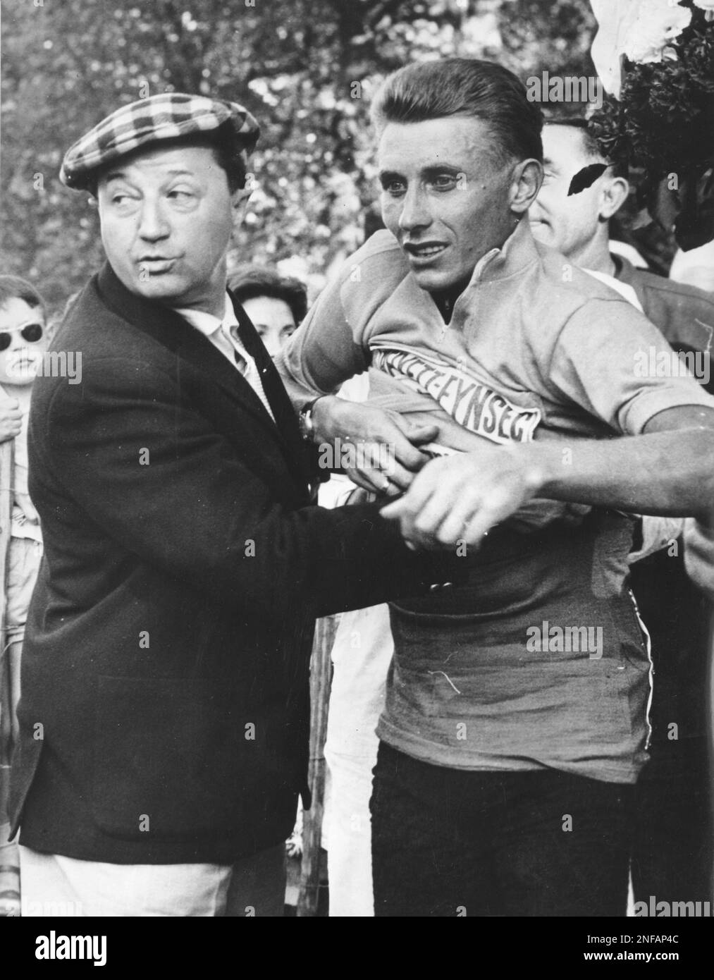 French pop singer Andre Dassary, left. helps French cycling ace Jacques ...