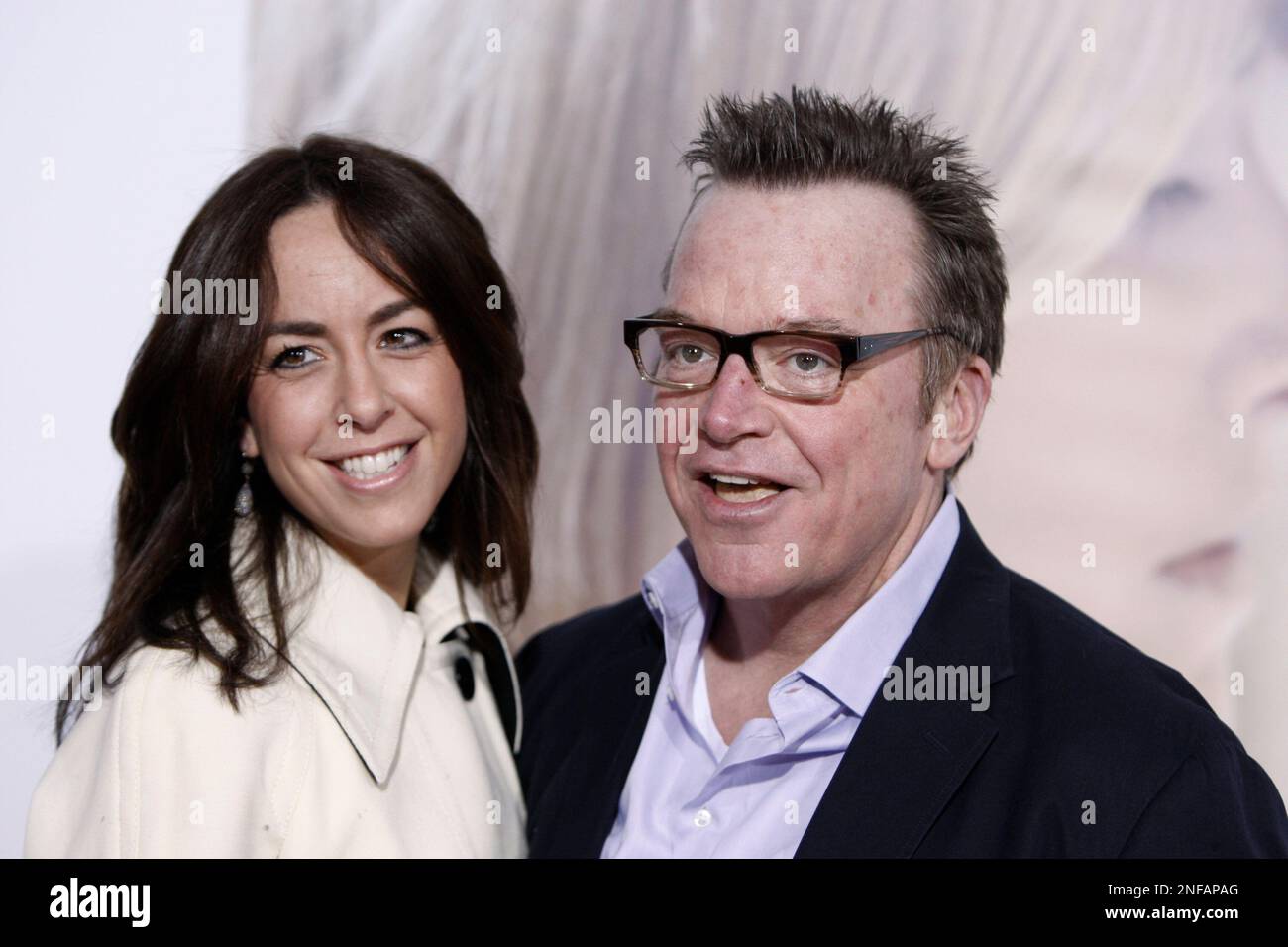 Tom Arnold, right, arrives at the premiere of "Revolutionary Road" in ...
