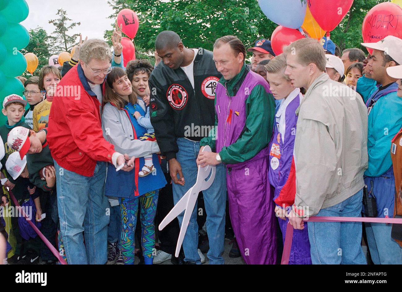 Former Los Angeles Lakers star Earvin "Magic" Johnson, center, watches ...