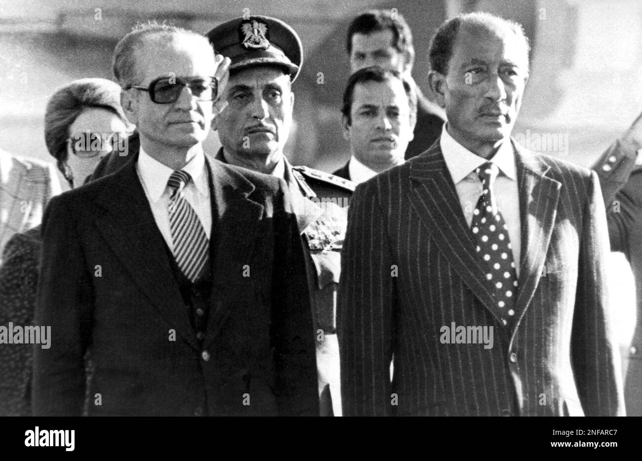 The Shah of Iran, left, stands with Egyptian President Anwar Sadat at ...
