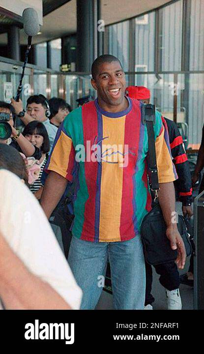 Former NBA superstar Magic Johnson smiles upon arrival at the new Tokyo ...