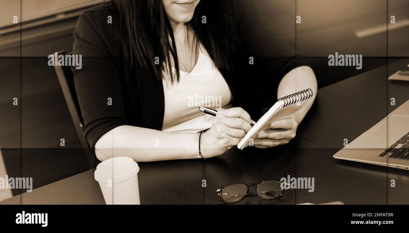 Young woman taking notes on notepad, geometric pattern Stock Photo - Alamy
