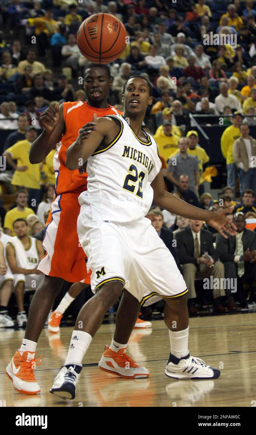 Savannah State forward Rashad Hassan, back, and Michigan forward Jevohn ...