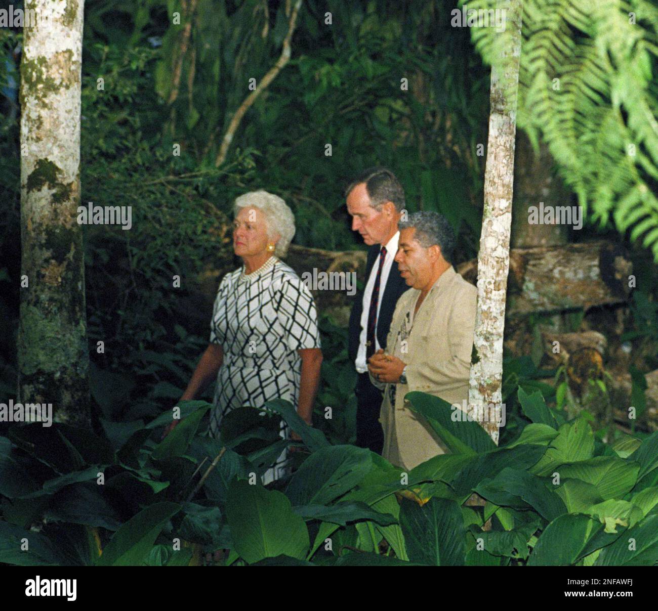 U.S. President George Bush and his wife Barbara are guided through a ...