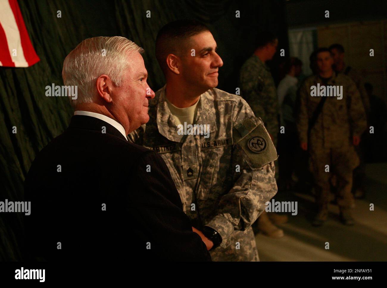 Defense Secretary Robert Gates poses for a picture with a soldier after ...