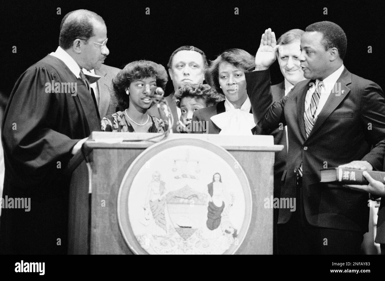 W. Wilson Goode, right, raises his hand as he takes the oath of the ...