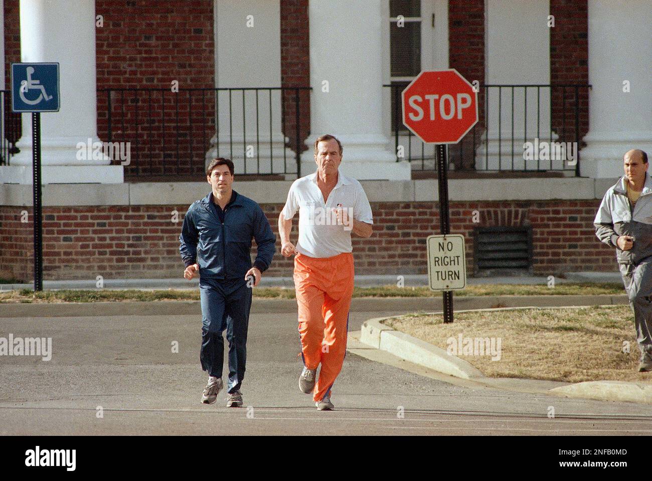 President George Bush, in the company of a Secret Service agent, goes ...