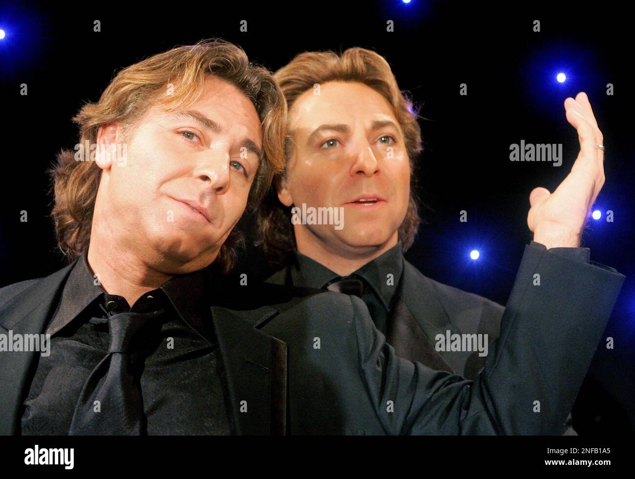French tenor singer Roberto Alagna, left, poses next to his life-size ...