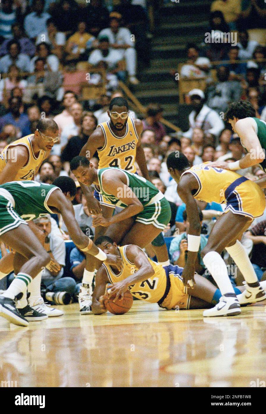 Earvin "Magic" Johnson of the Los Angeles Lakers scrambles for the ball ...