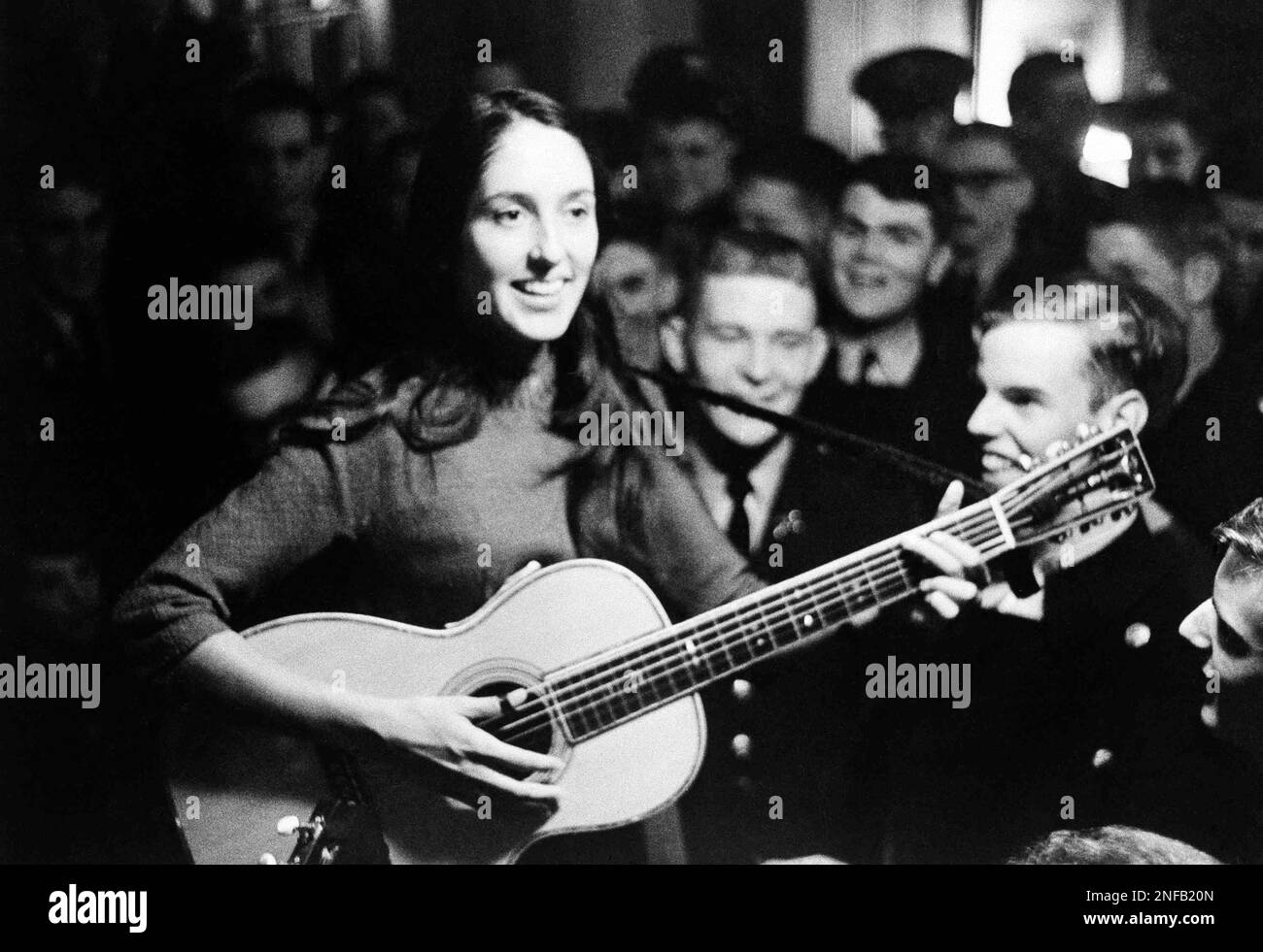Popular folk singer Joan Baez, wears the long hair and high-necked ...