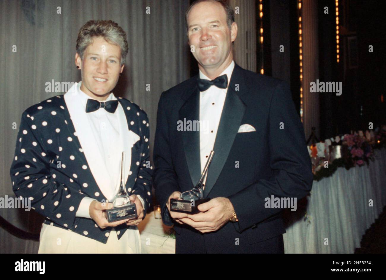 Golfers Patty Sheehan, left, and Tom Weiskopf hold crystal golf club ...