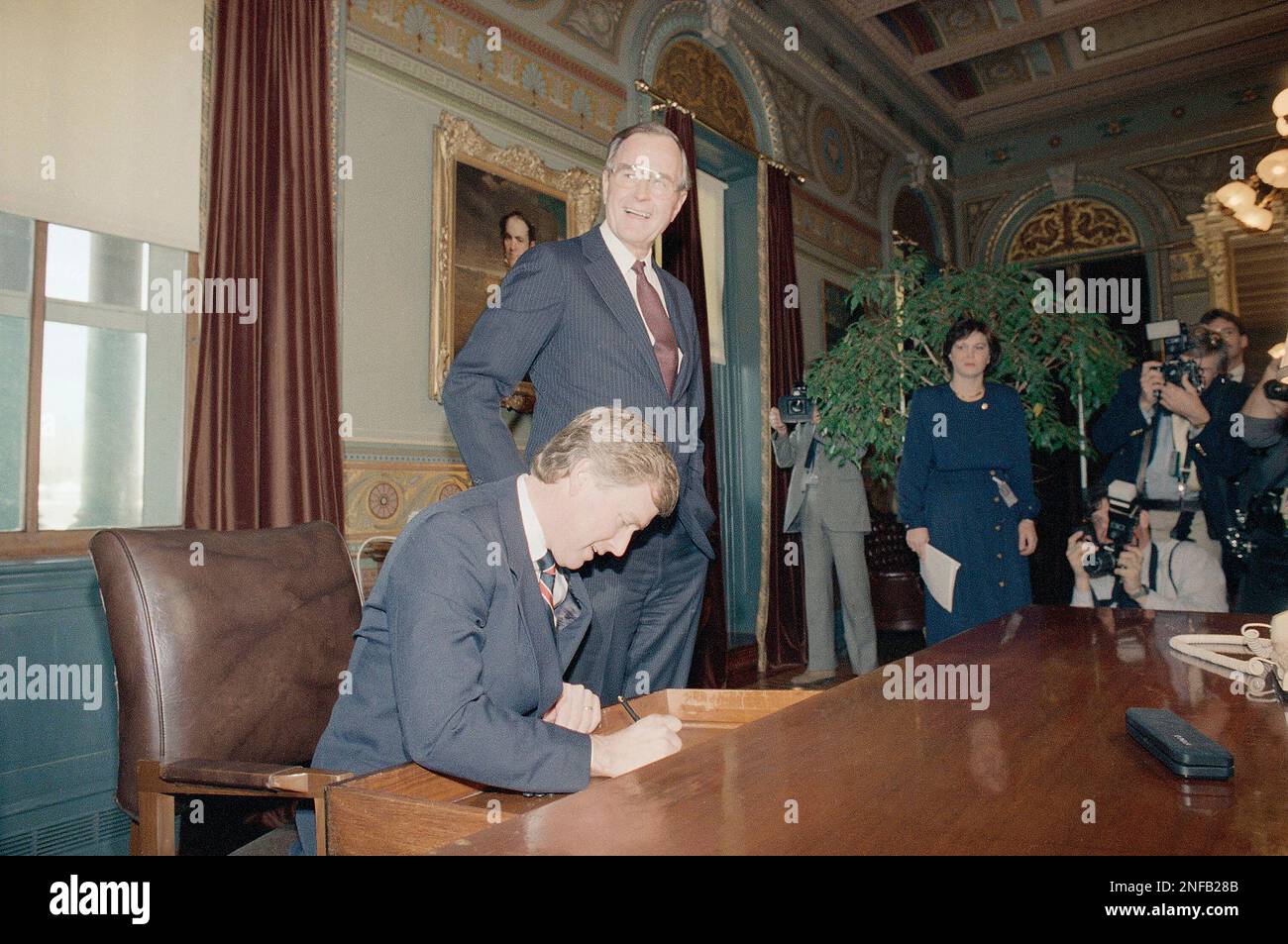 President George Bush and Vice President Dan Quayle point to signatures ...