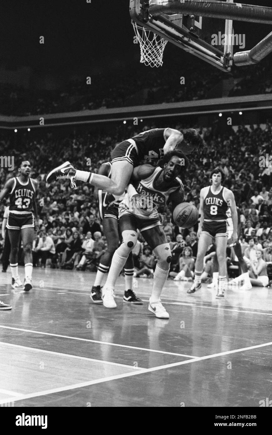 Boston Celtics Danny Ainge (44) goes over the back of Atlanta Hawks Dan ...