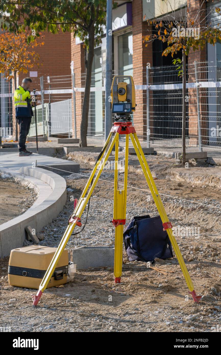 Total station with yellow tachymeter or theodolite with tripod to ...